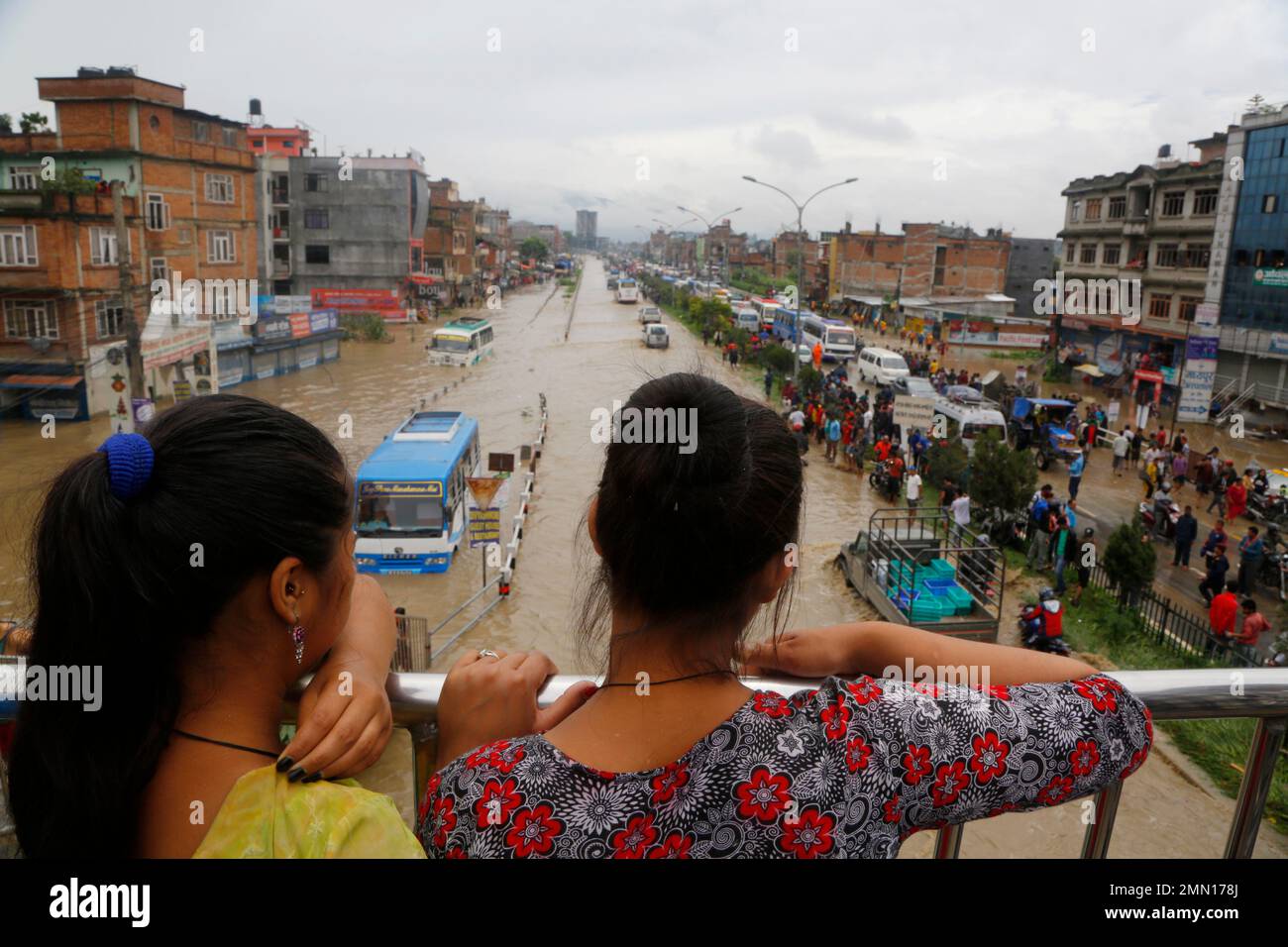 Nepalese women look at a flood area in Bhaktapur, Nepal, Thursday, July ...