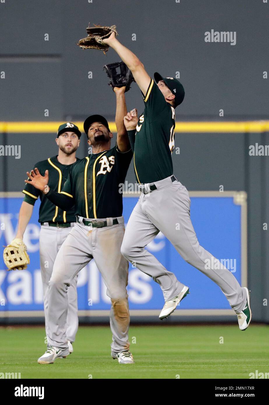 Oakland Athletics right fielder Chad Pinder, right, makes the catch of ...