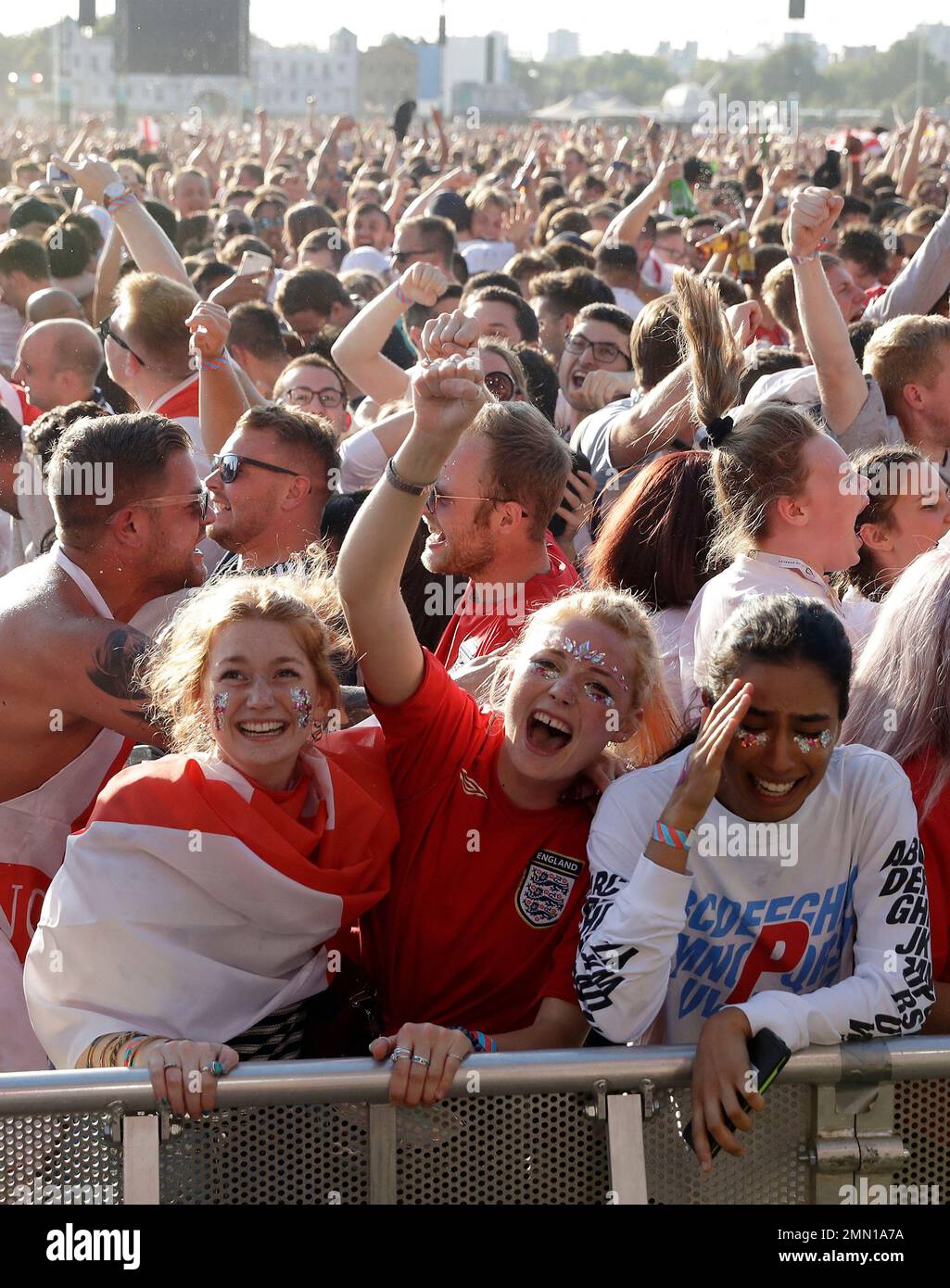 England soccer fans celebrates England's first goal as they watch a ...
