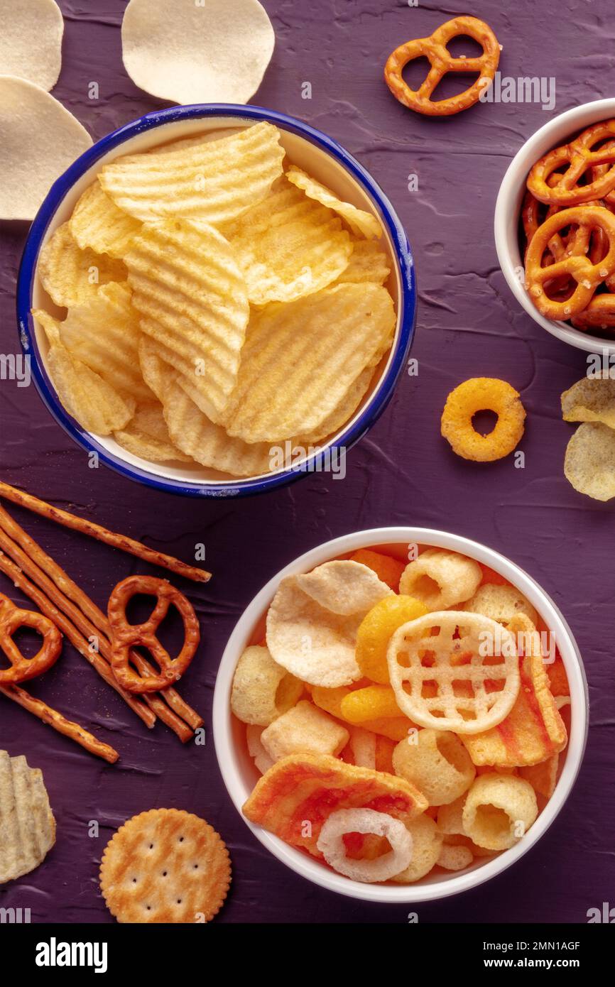 Potato chips and other salty snacks, shot from the top. Party food ...
