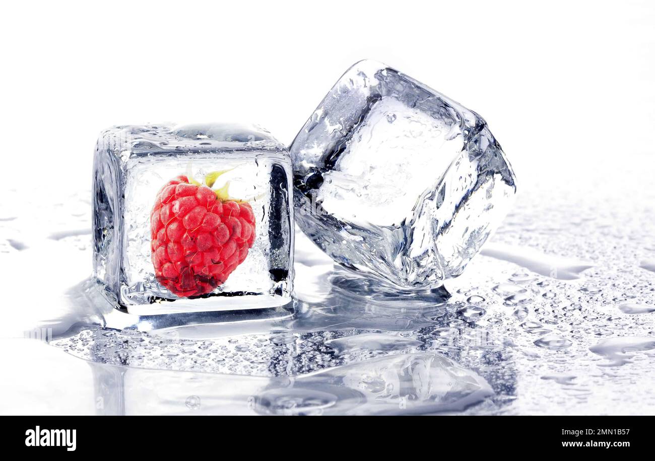 Raspberry frozen in ice cube. two ice cube Stock Photo - Alamy