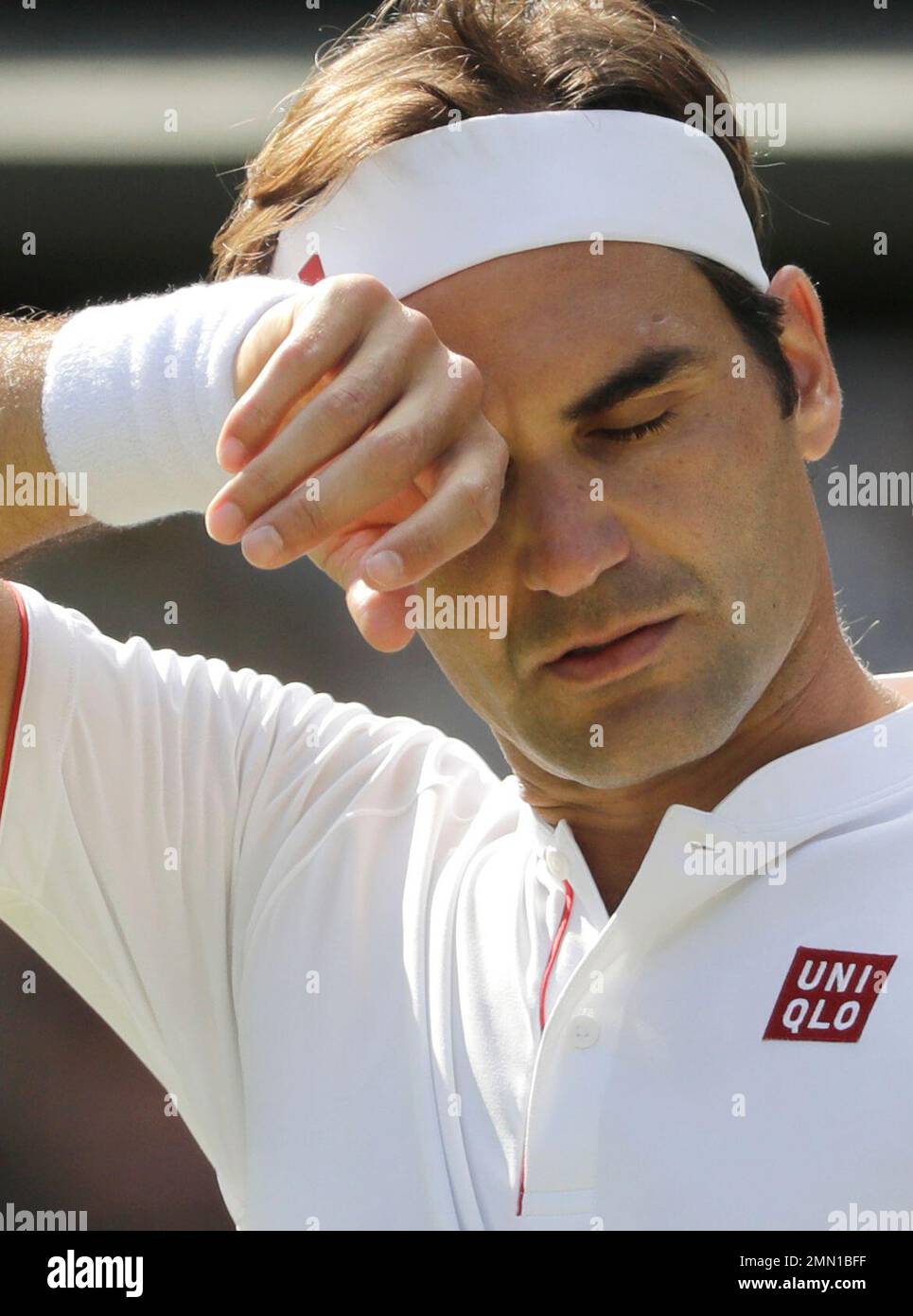 Switzerland's Roger Federer wipes his forehead during the fifth set of ...