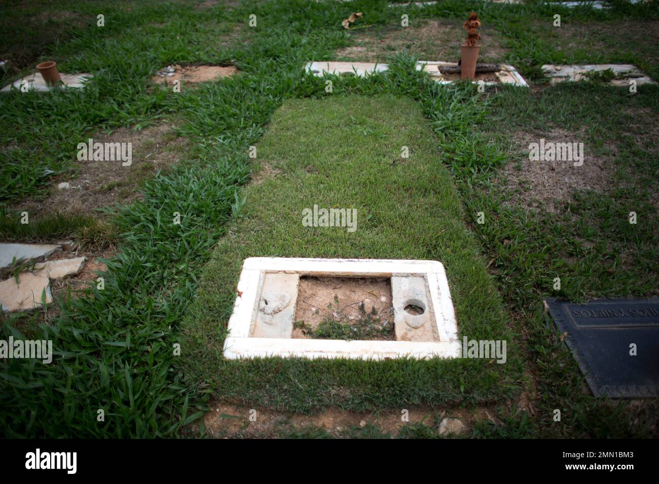 This June 19, 2018 photo shows a grave site with a missing headstone at ...