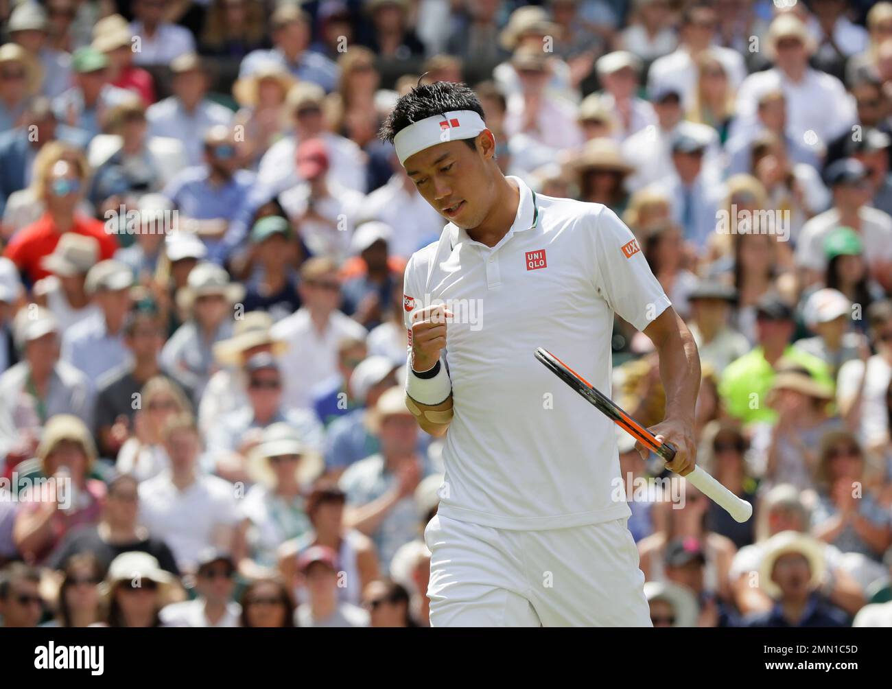 Kei Nishikori of Japan celebrates winning a point from Novak Djokovic ...