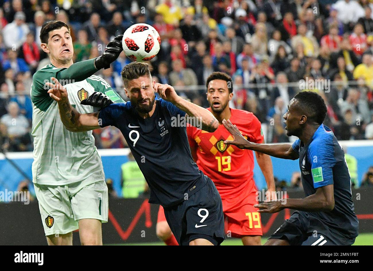 Belgium goalkeeper Thibaut Courtois, left, clears a ball ahead of ...