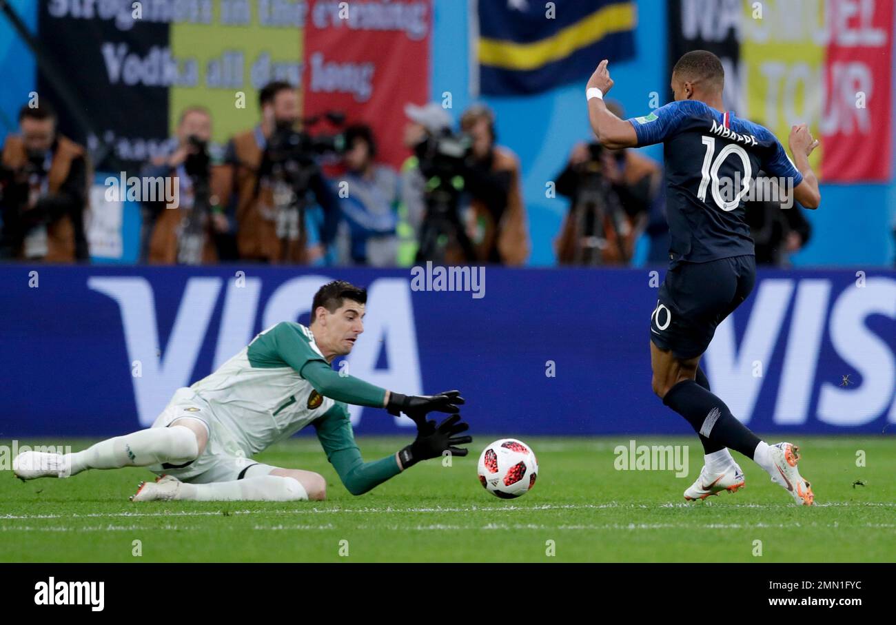 Belgium goalkeeper Thibaut Courtois makes a save on France's Kylian ...