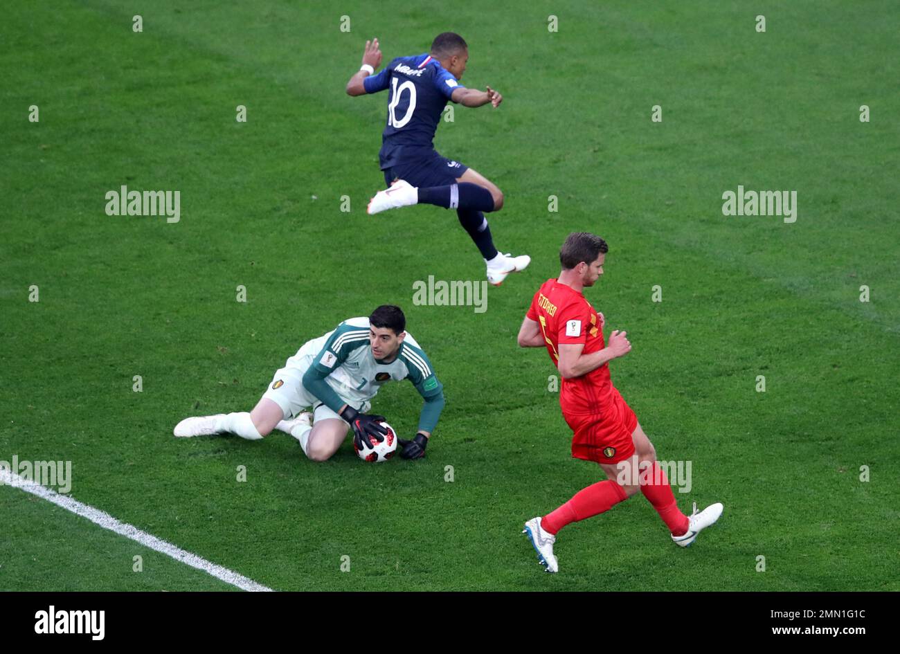 France's Kylian Mbappe leaps over Belgium goalkeeper Thibaut Courtois ...