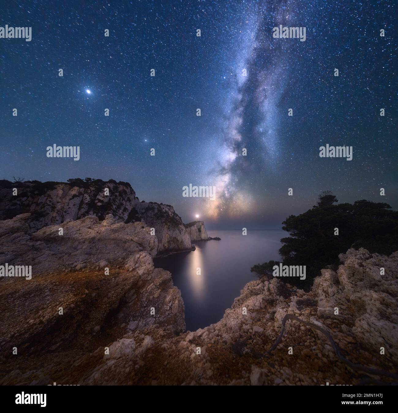 Milky Way and lighthouse on the mountain peak at starry night Stock ...