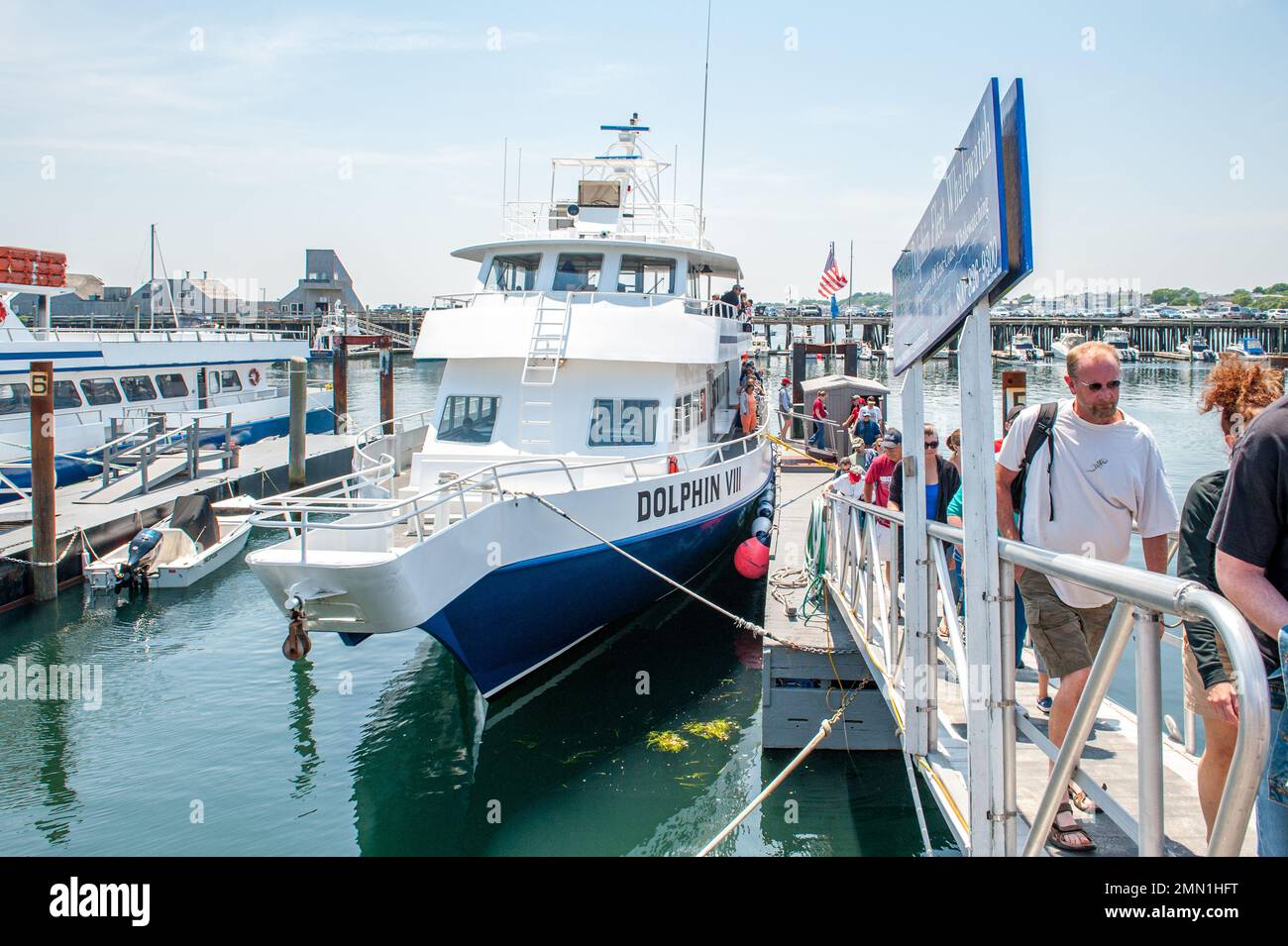 Tourists entering MacMillan Pier after a whale watch cruise in the ...