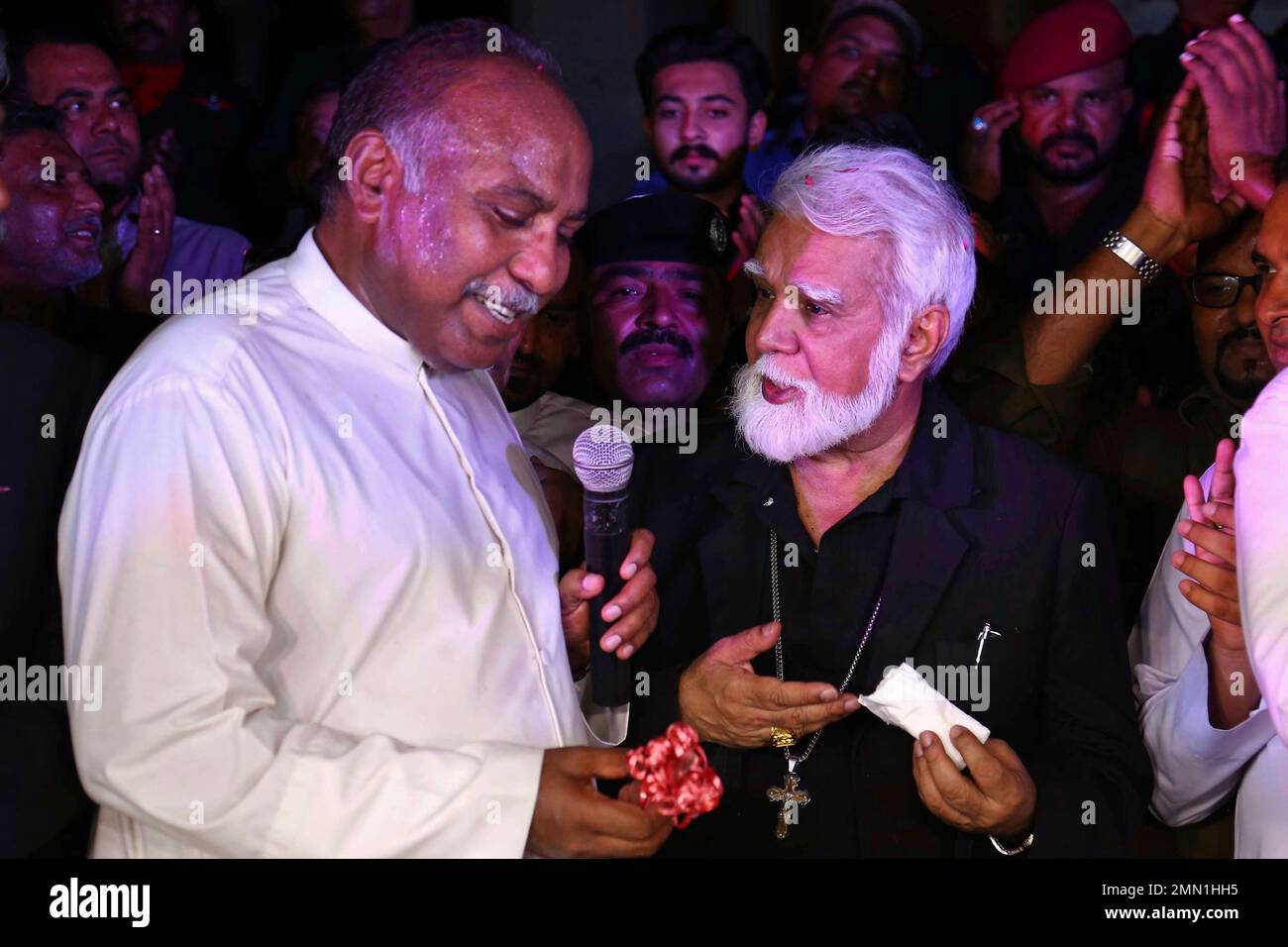 People receive Roman Catholic Cardinal Joseph Coutts at a reception in ...