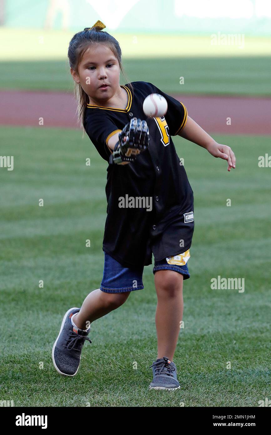Hailey Dawson, 8, of Las Vegas, throws out the ceremonial first pitch ...