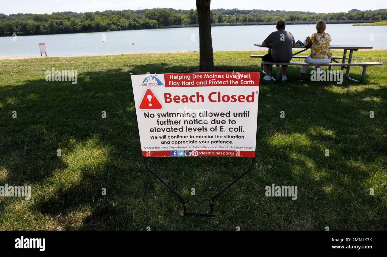 A beach closed sign is posted at the Gray's Lake Park beach warning of ...