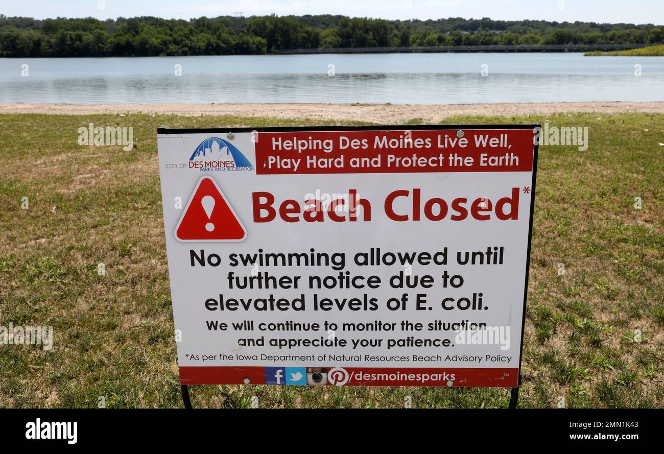 A beach closed sign is posted at the Gray's Lake Park beach warning of ...