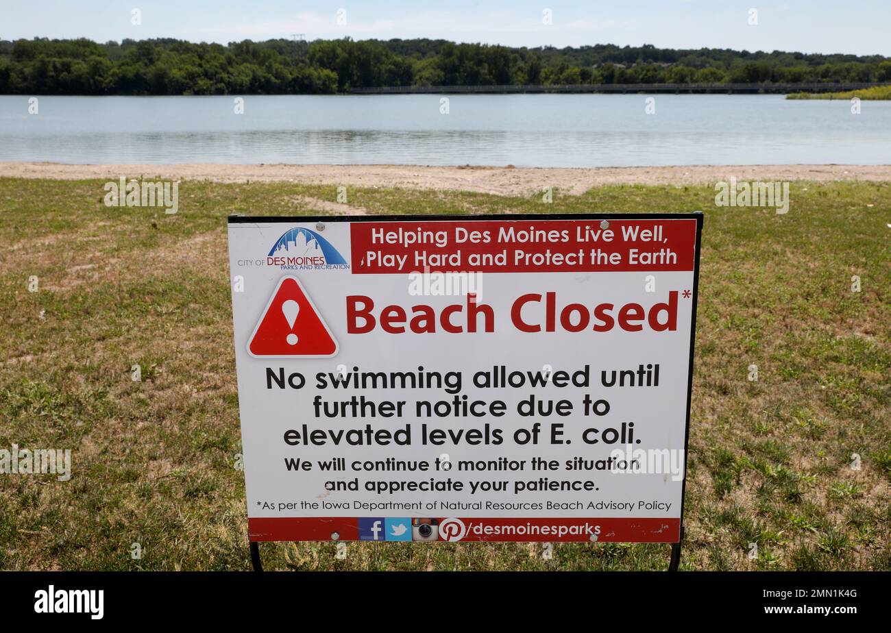 A beach closed sign is posted at the Gray's Lake Park beach warning of ...