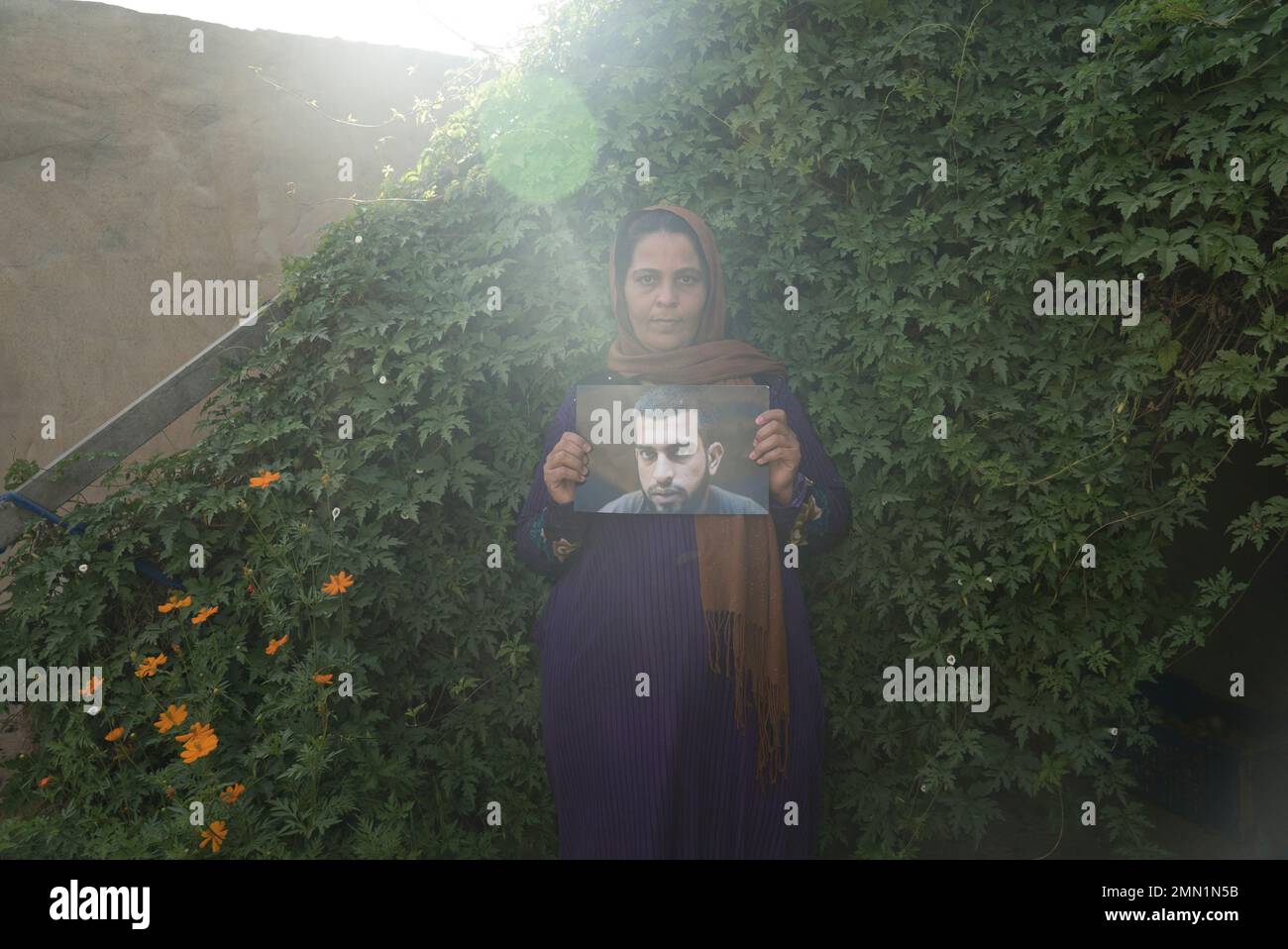 In this May 29, 2018 photo, Umm Quteiba poses for a portrait with a ...