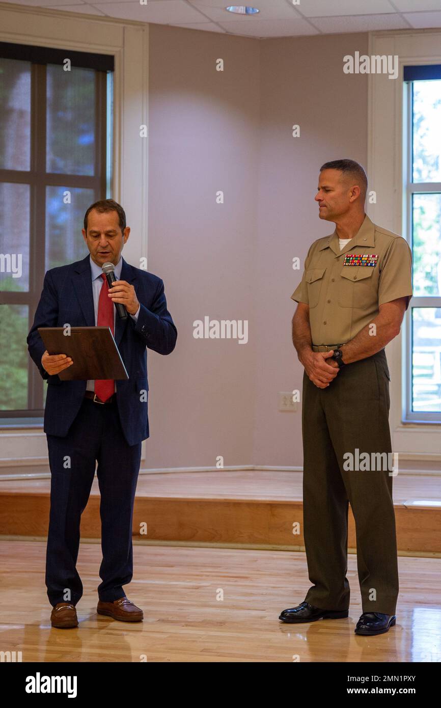 North Carolina State Senator Michael Lazzara, left, reads a citation ...