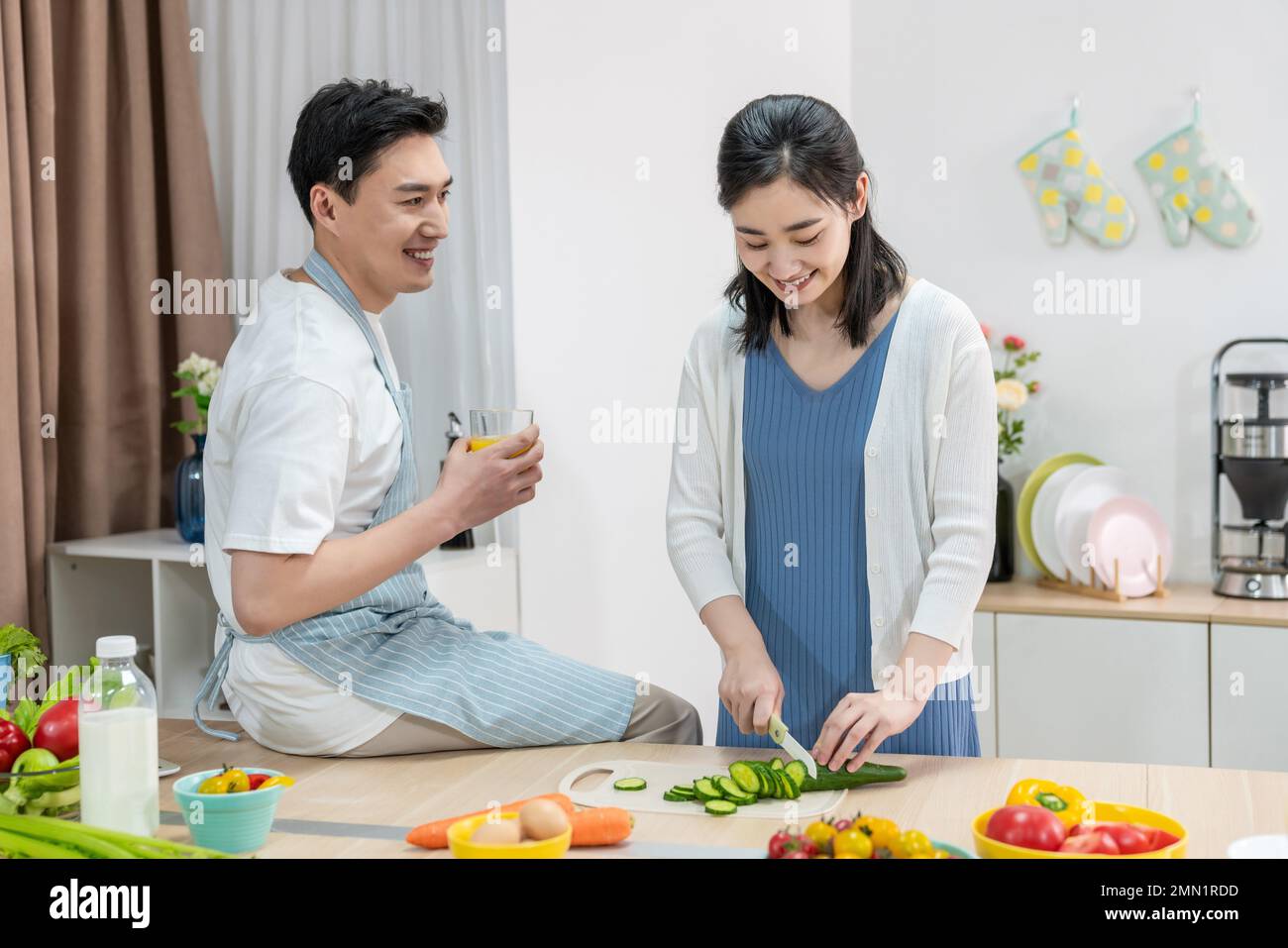 Young couples in the kitchen cooking Stock Photo - Alamy