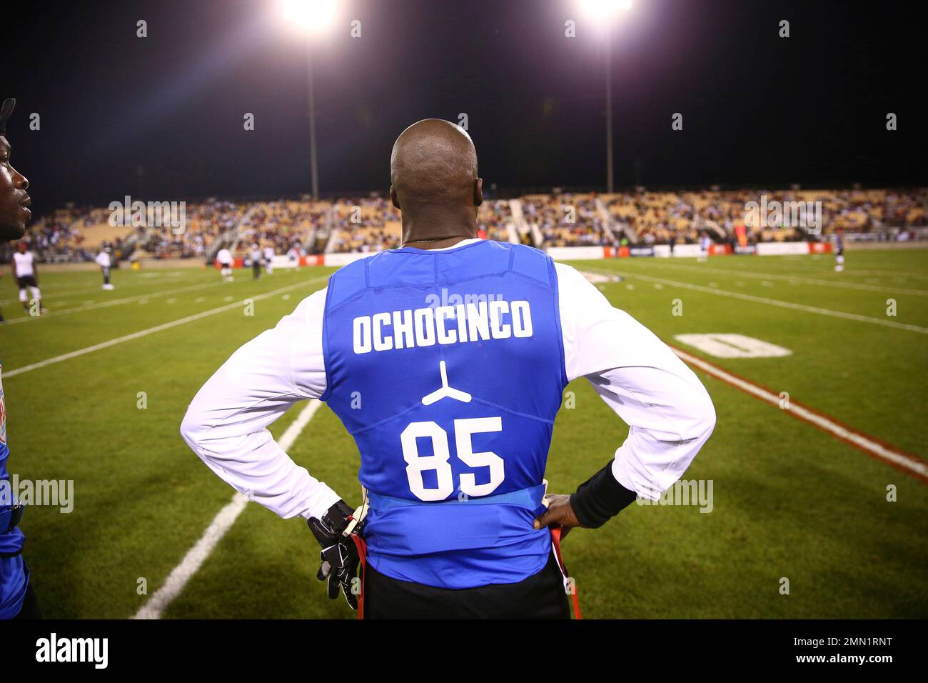 Ocho's Chad Ochocinco' stands on the sidelines during a semifinal game ...