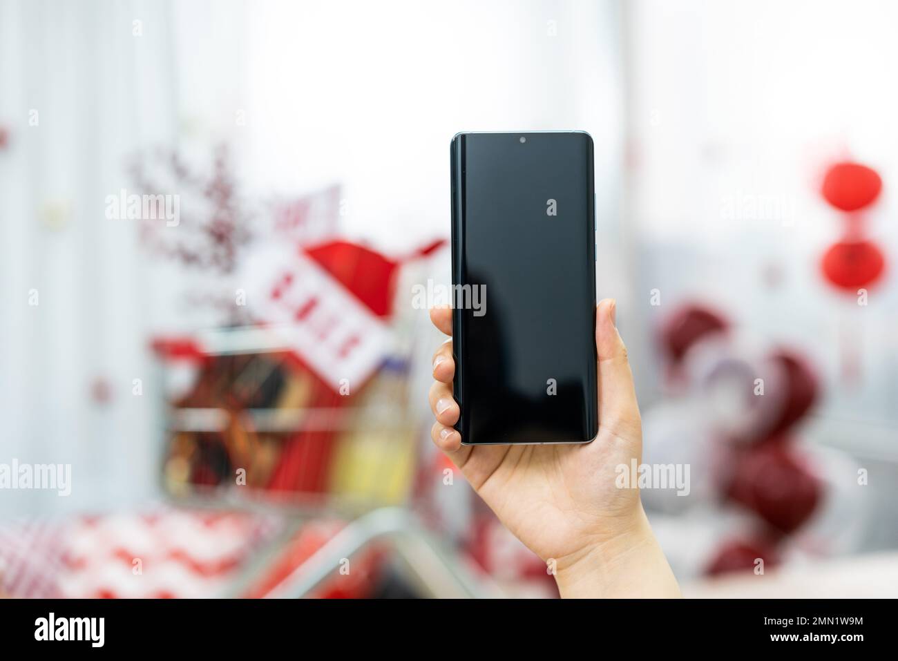 Mobile phones and a shopping cart Stock Photo - Alamy