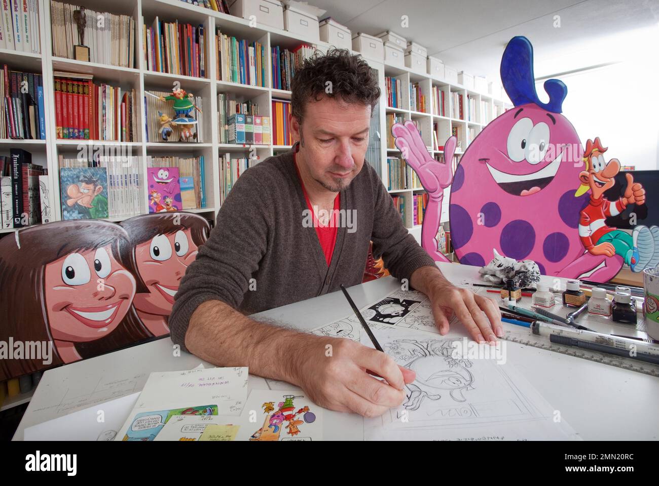 Europe, Netherlands, comic artist Gerard Leever at work in his studio ...