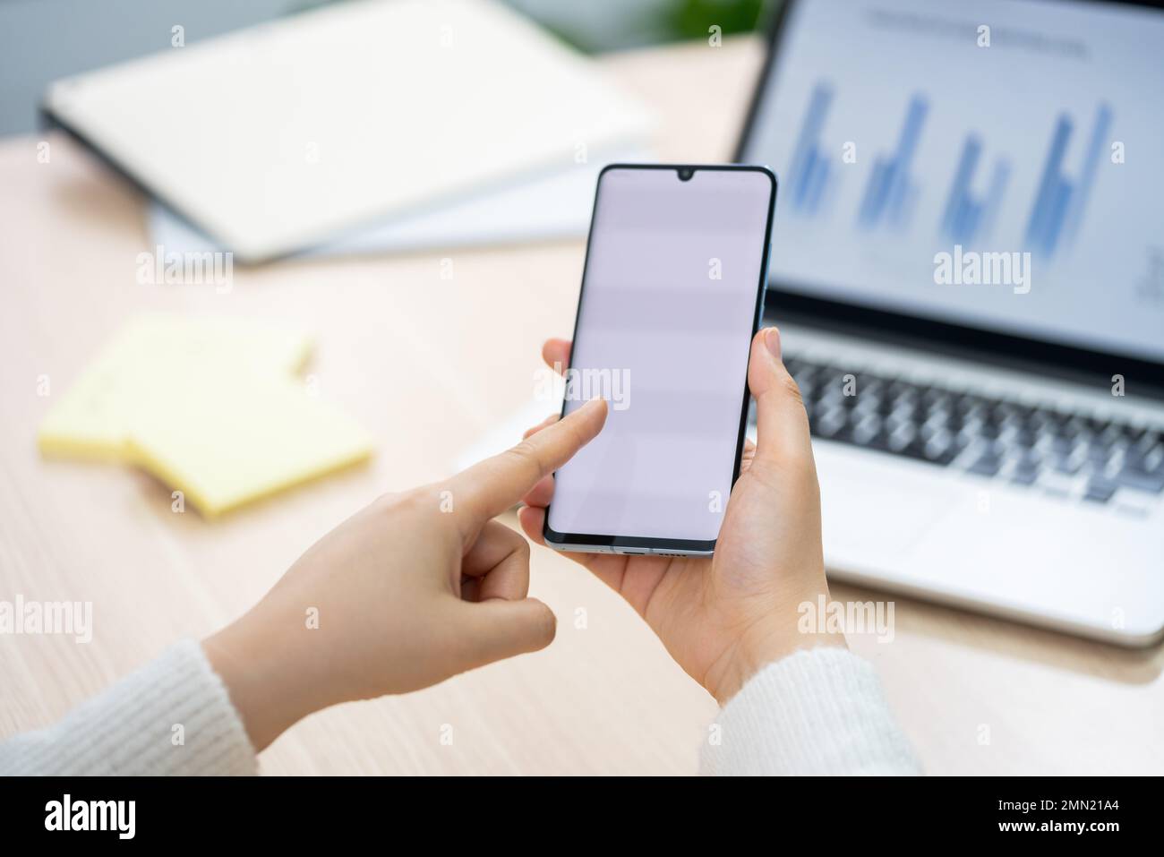 Young women who use mobile phones and laptop computers Stock Photo - Alamy