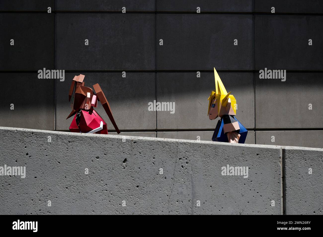Two attendees dressed as animation characters walk up a ramp during the ...