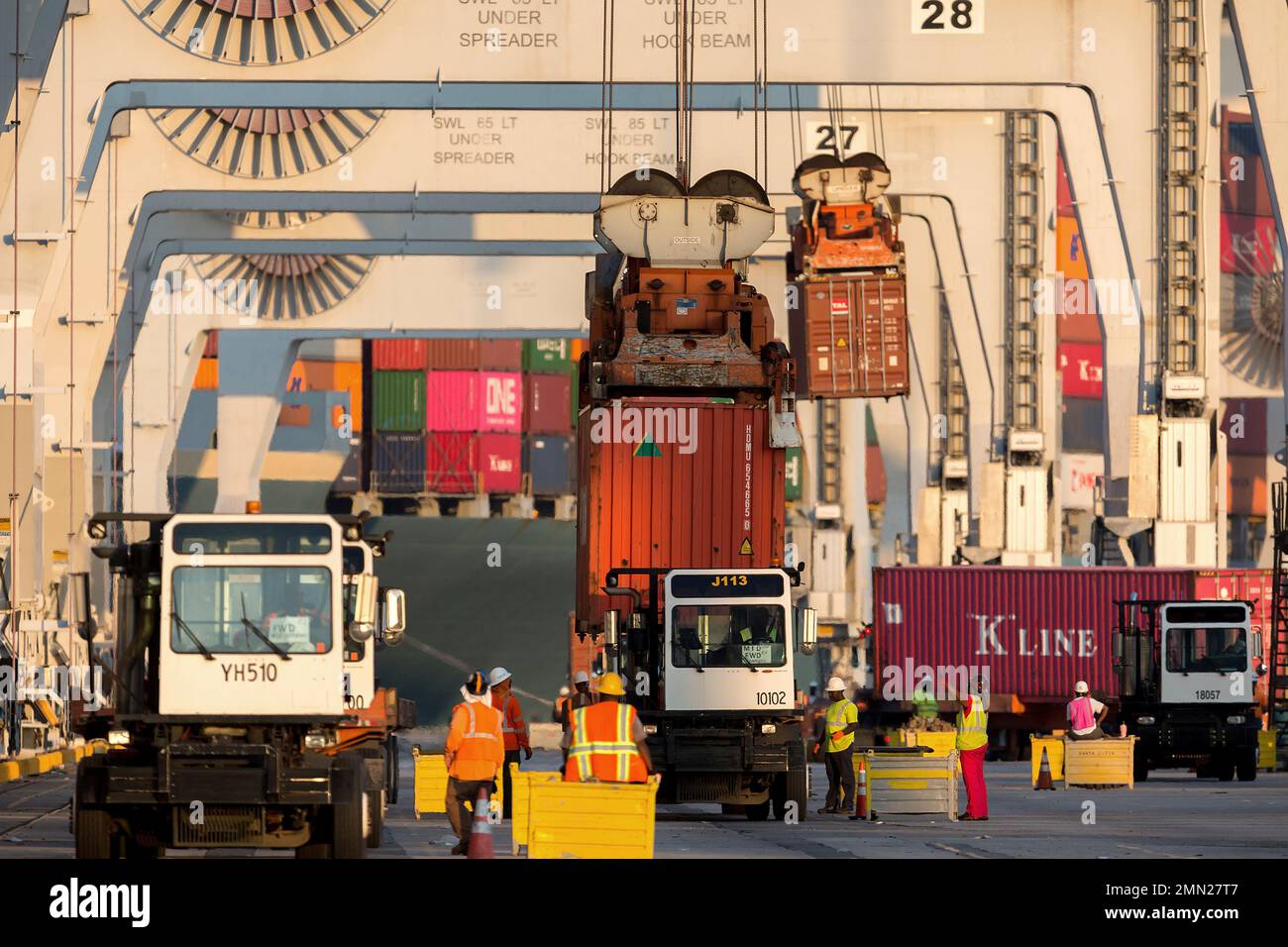 In this June, 19, 2018 photo, a gang of longshoremen move shipping ...