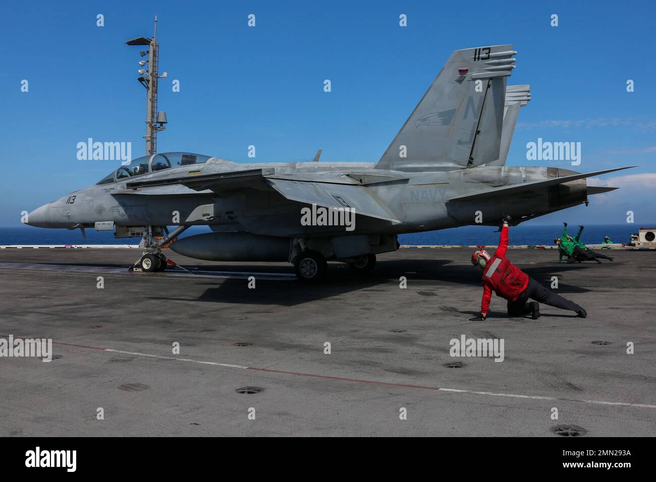 PACIFIC OCEAN (Sept. 24, 2022) Sailors signal an F/A-18F Super Hornet ...