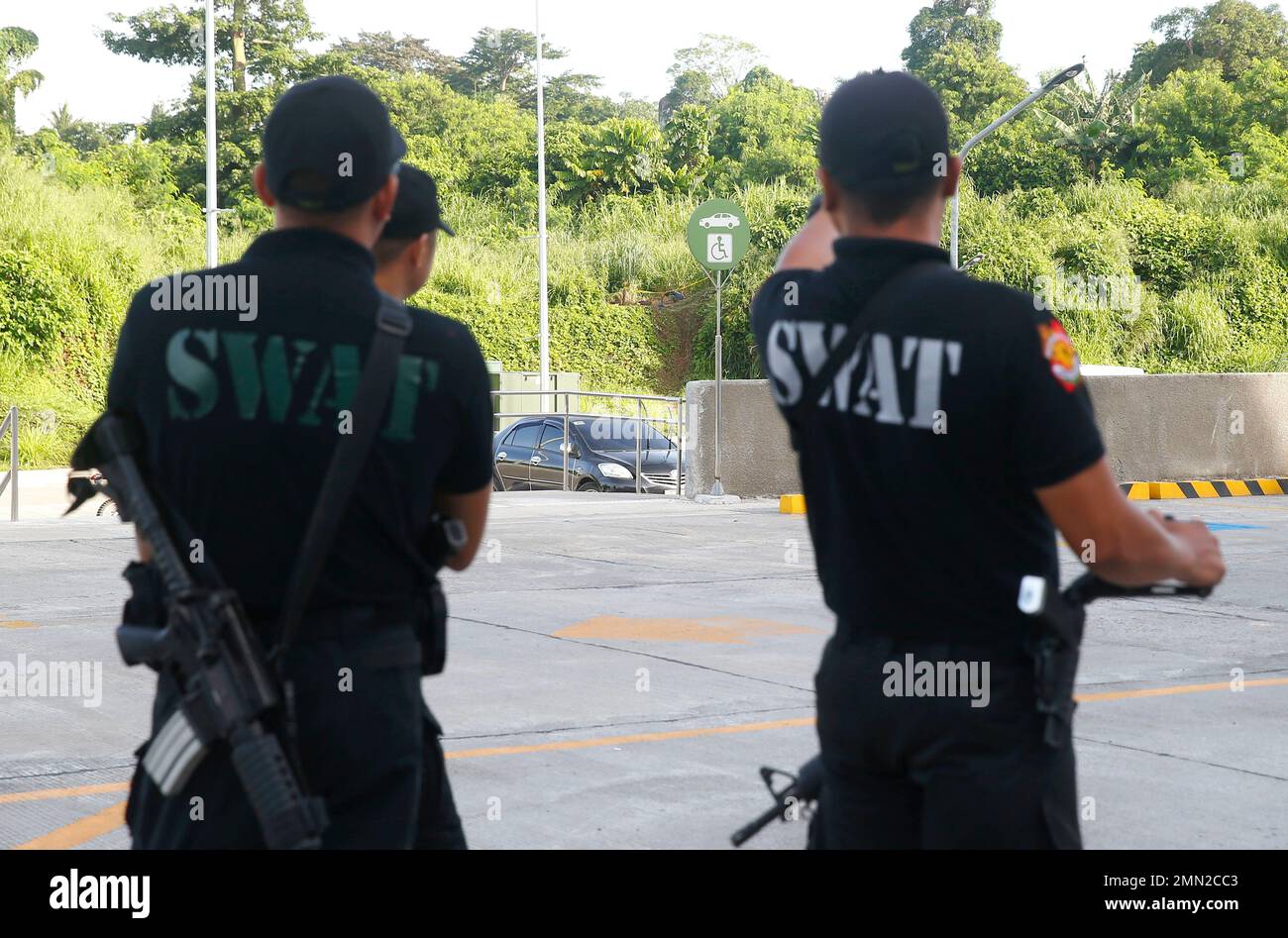 Philippine National Police SWAT members check a position of a gunman ...
