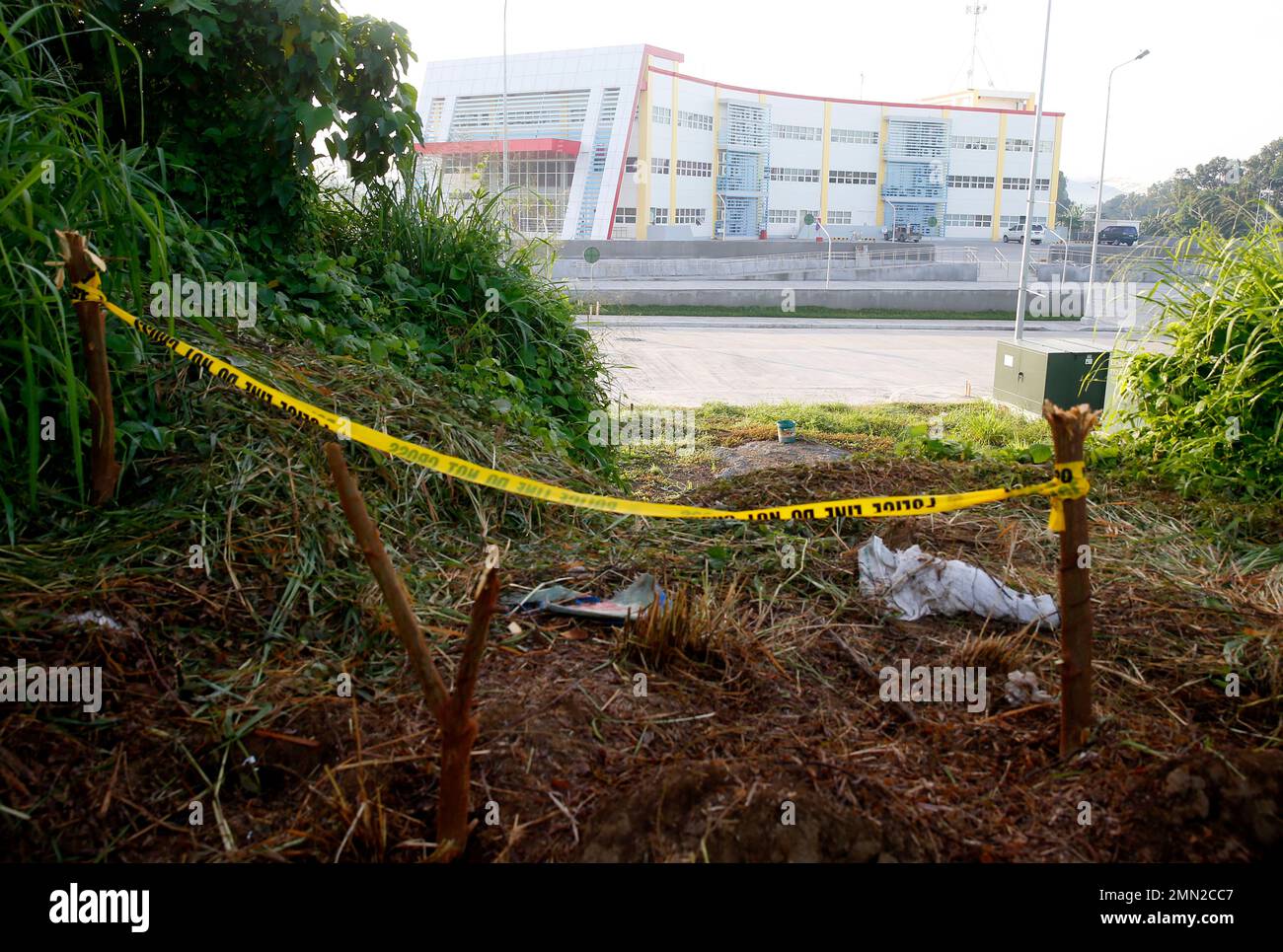 A twig at bottom, left, is placed at the spot where a gunman was ...