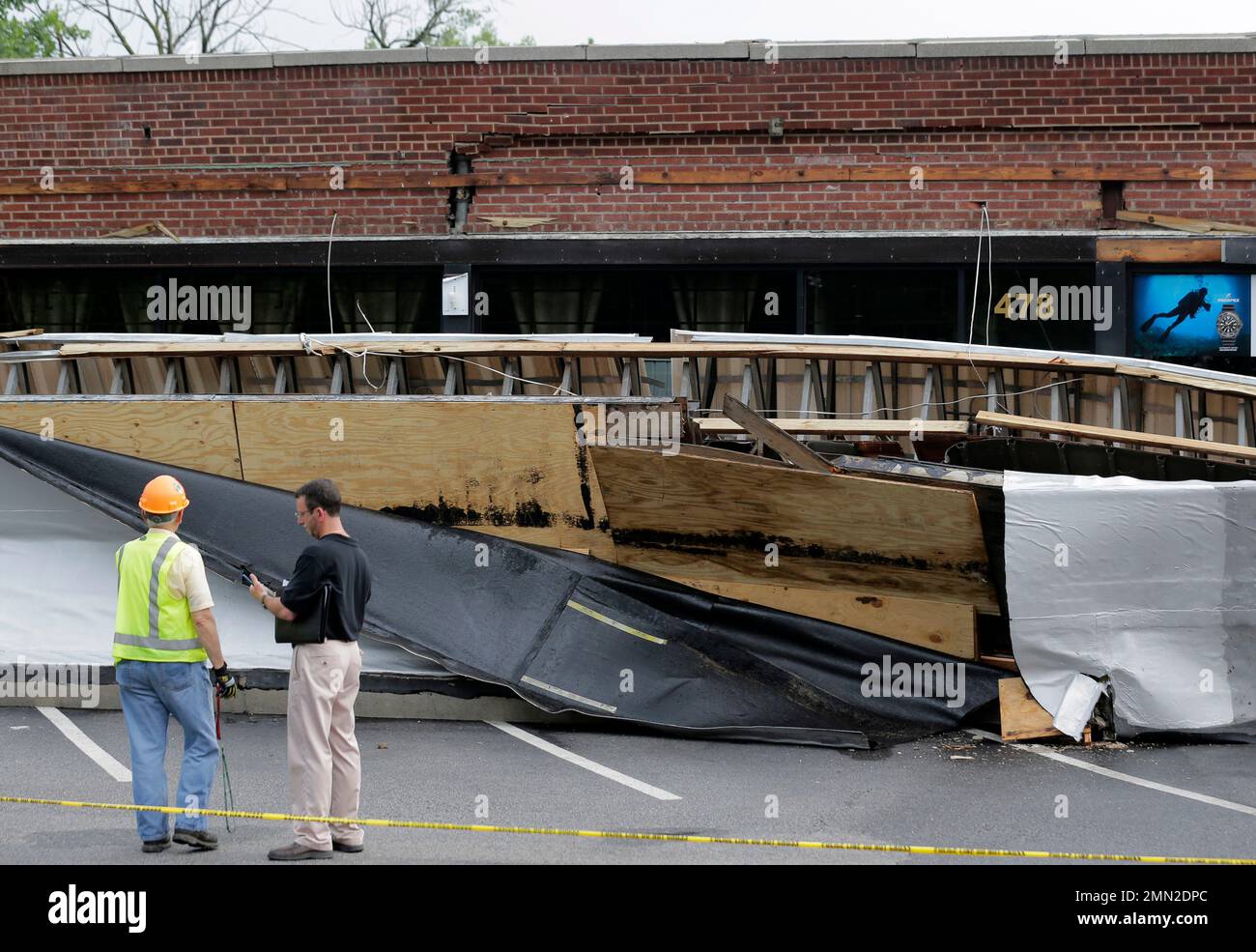 A portion of a strip mall whose facade collapsed is seen in River Edge ...