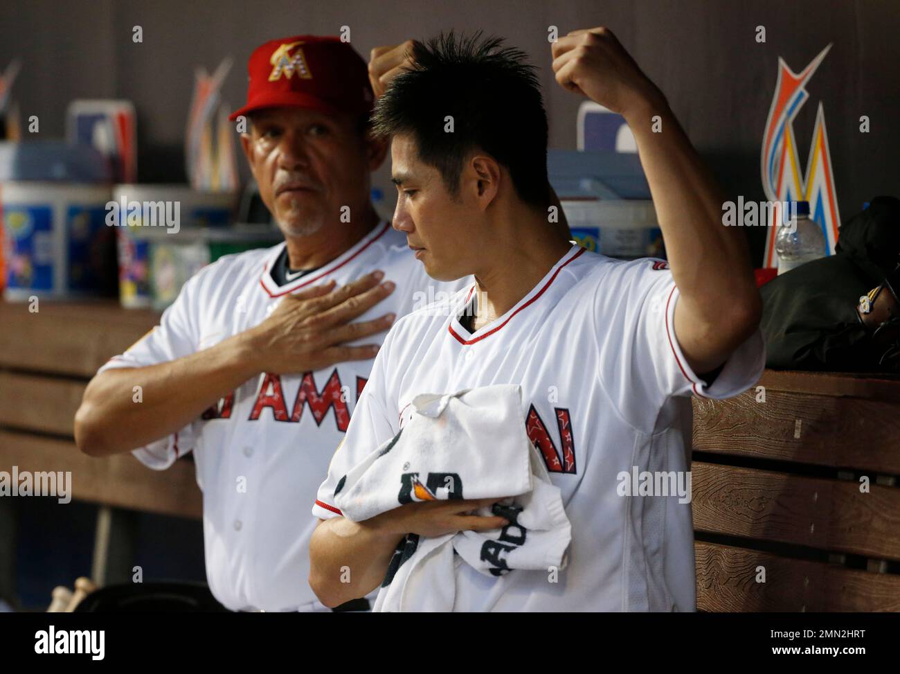 Miami Marlins starting pitcher Wei-Yin Chen, right, of Taiwan, talks to ...