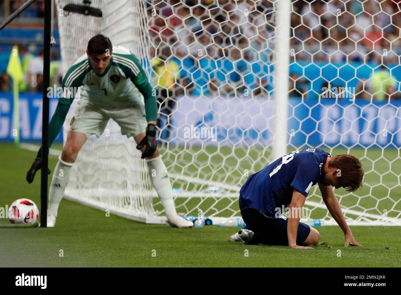 Japan's Takashi Inui, right, gets up next to Belgium goalkeeper Thibaut ...