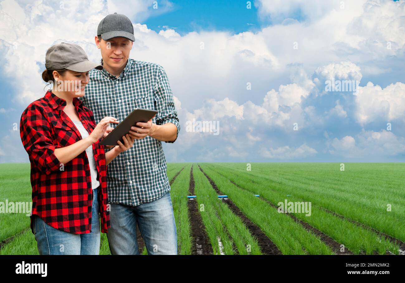 Couple of farmers with digital tablet on a field. Smart farming and ...