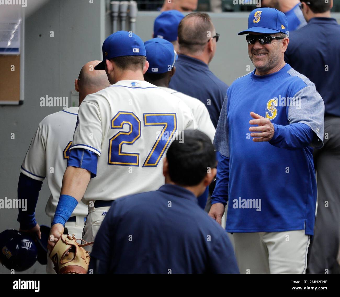 Seattle Mariners hitting coach Edgar Martinez, right, greets Ryon Healy ...