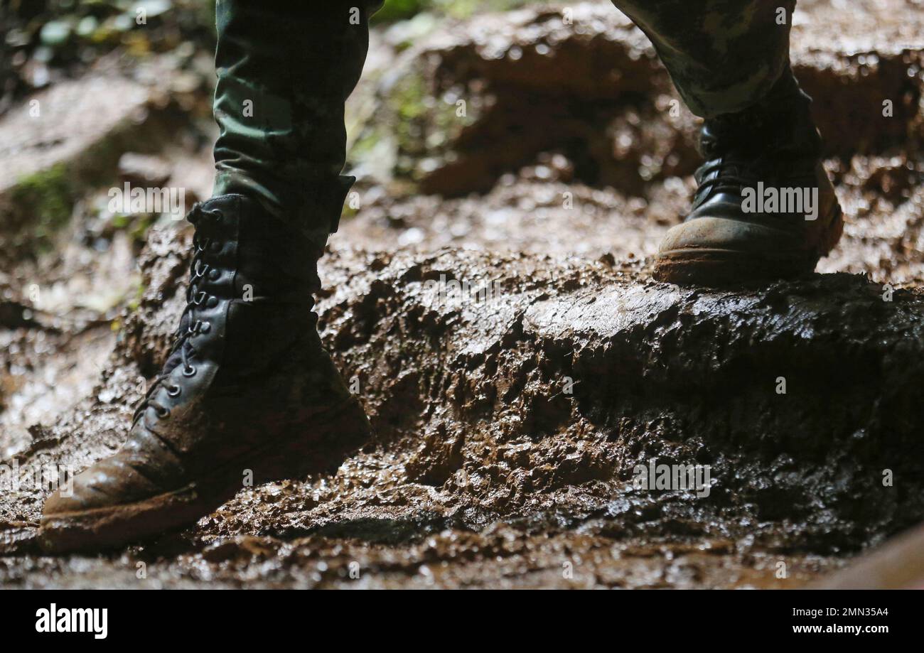 In this Thursday, June 28, 2018, photo, a soldier walks through thick ...