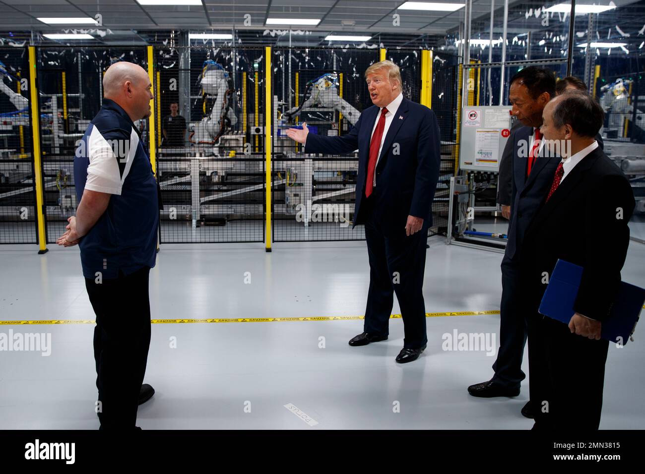 President Donald Trump talks with a Foxconn employee during a tour of ...
