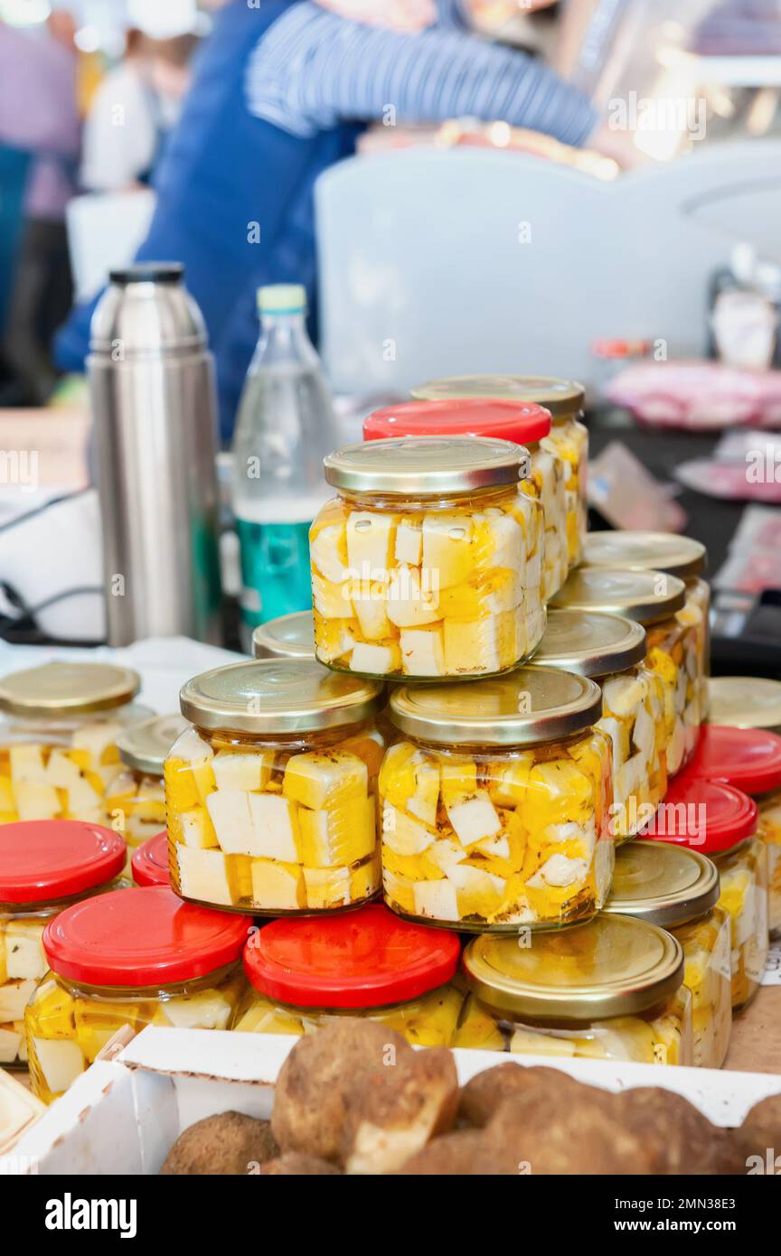 Pickled feta in a jar. Farm products are presented at the fair. Russian ...