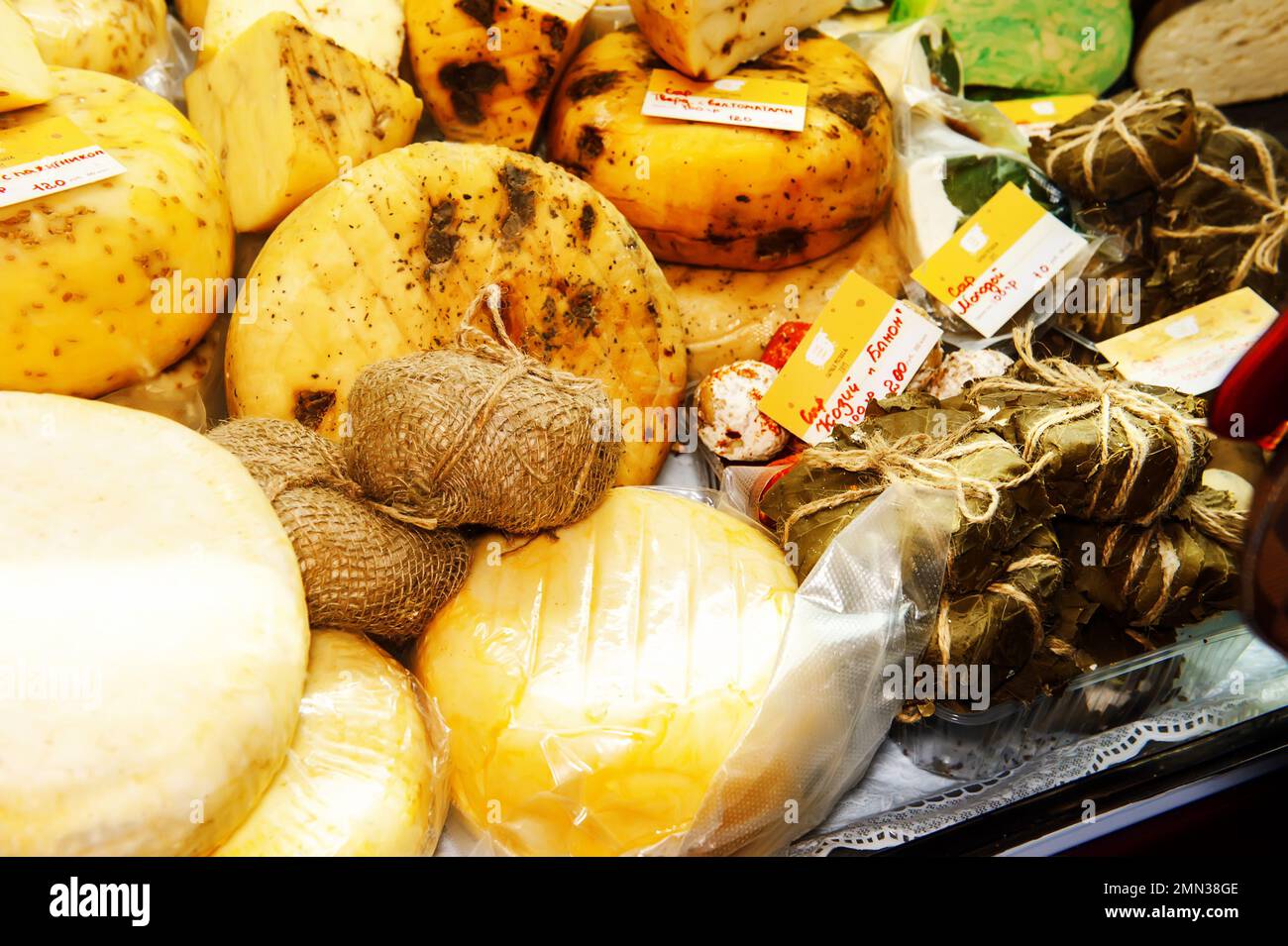 Sale of cheese of different varieties at the farm fair. Cheese from ...