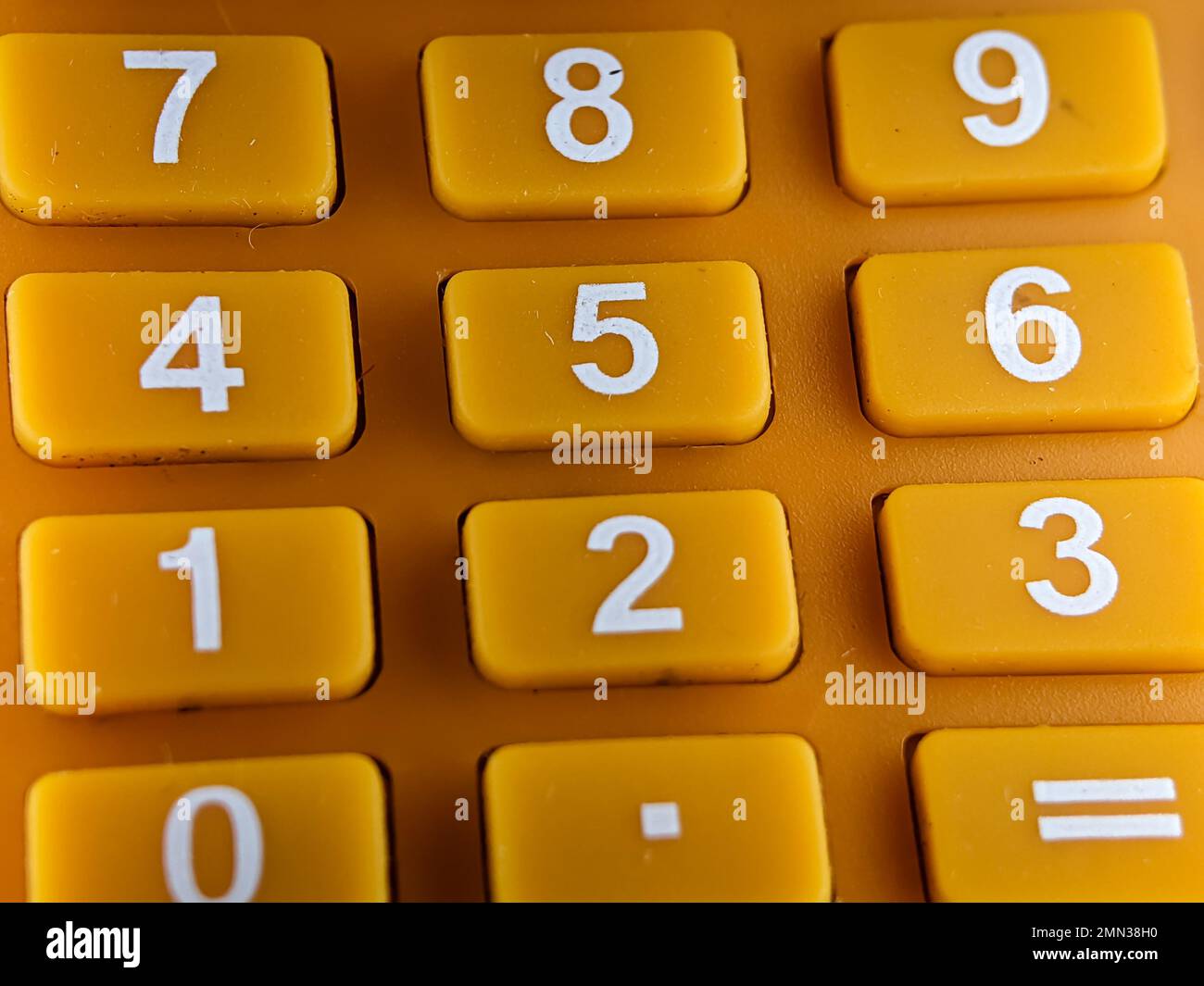 Close-up of number on a orange calculator. Background and textured ...