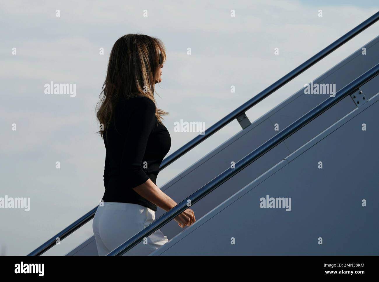 First lady Melania Trump boards an airplane at Andrews Air Force Base ...