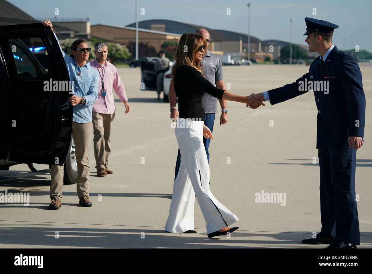 First lady Melania Trump is greeted as she boards an airplane at ...