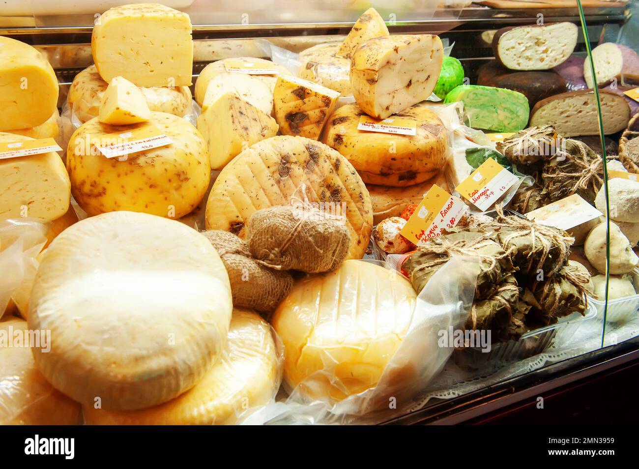Sale of cheese of different varieties at the farm fair. Cheese from ...