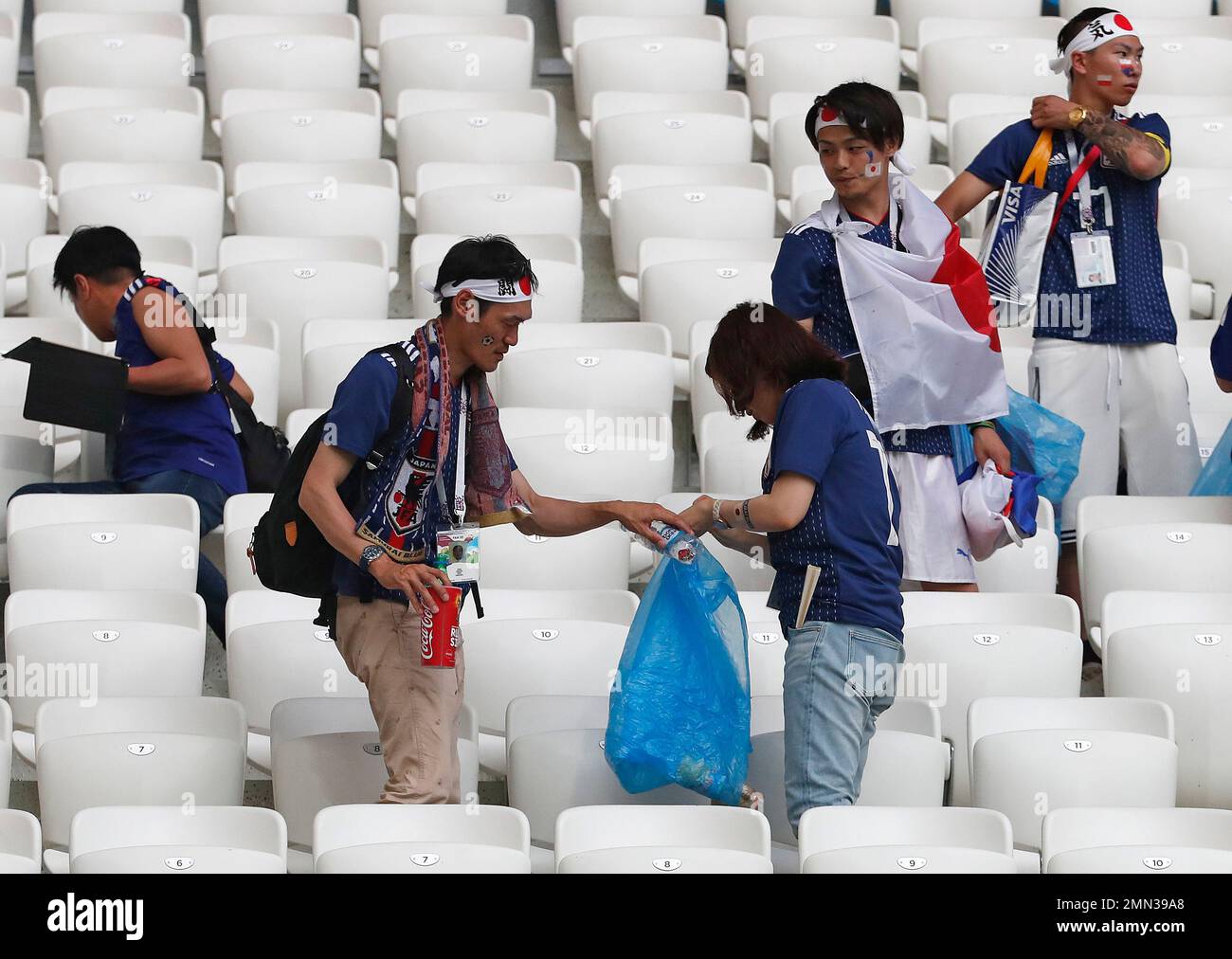 Japanese supporters clear litter from the stands after the group H ...