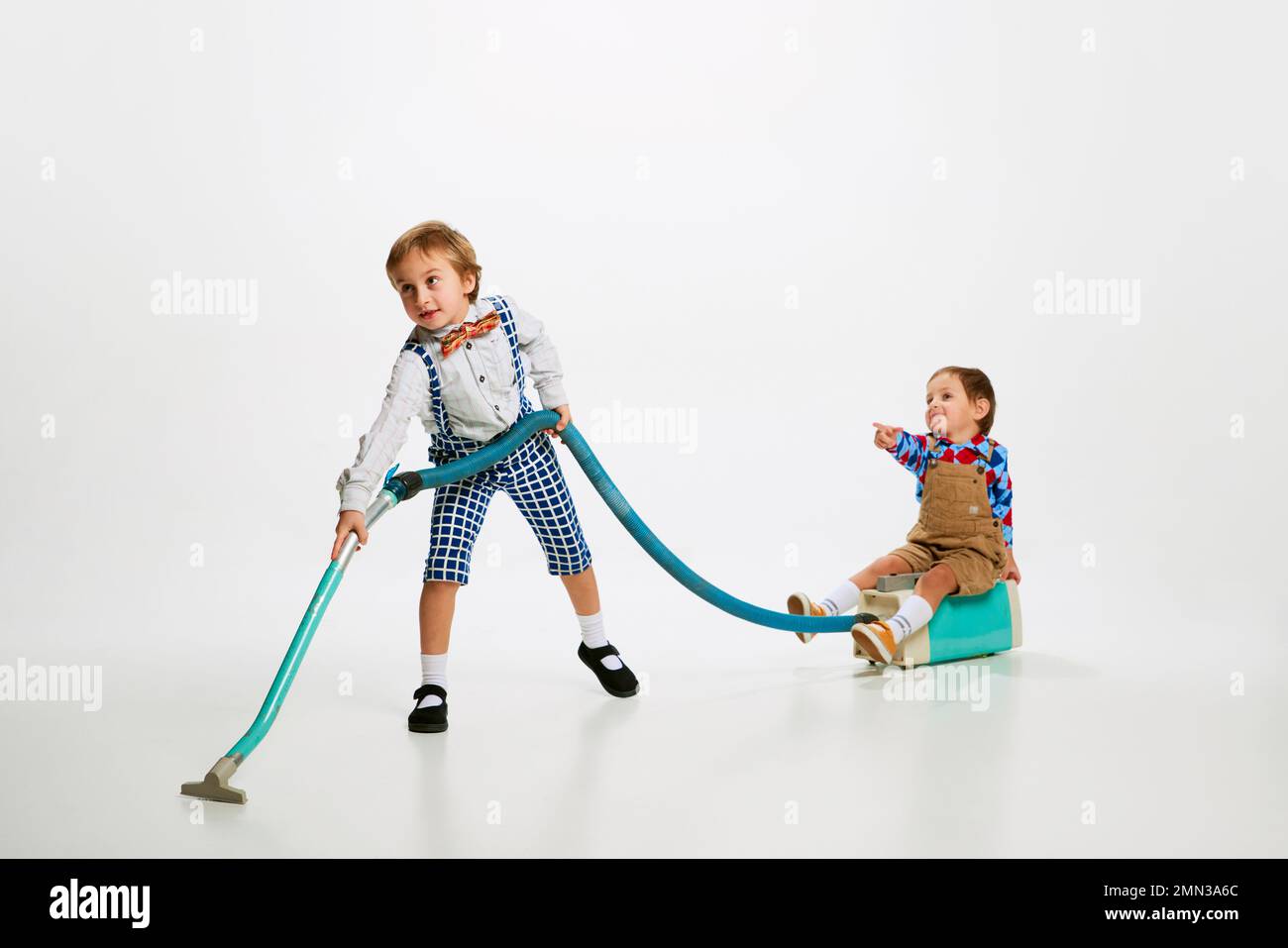 Happy brother. Little kids, boys cleaning house with vacuum cleaner and ...