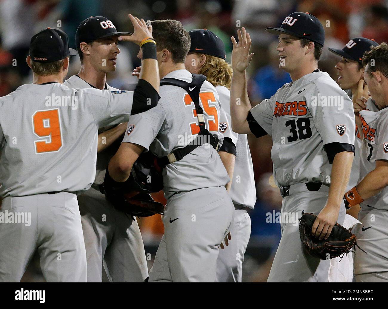 Oregon State pitcher Jake Mulholland (38) celebrates with infielder ...