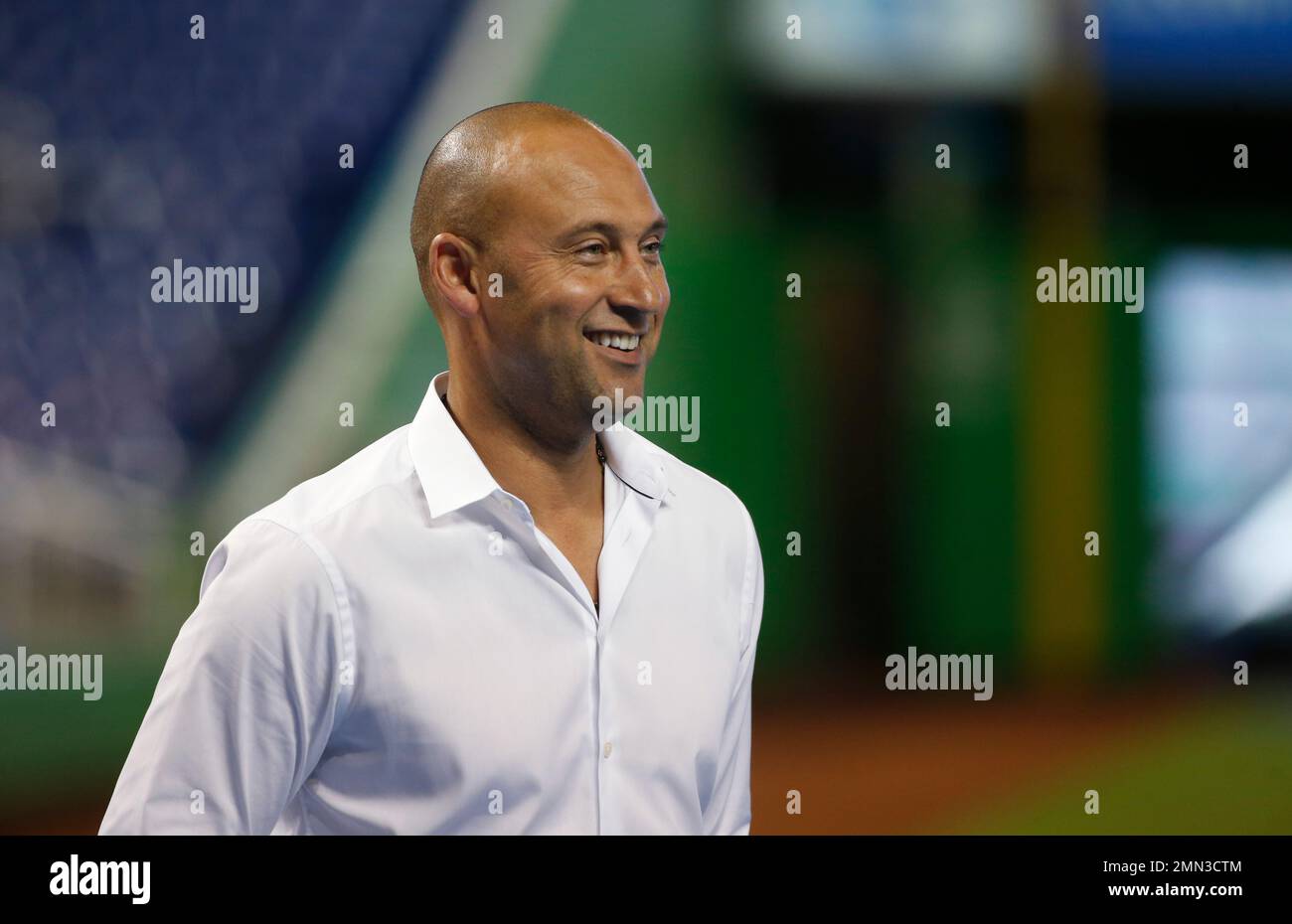 Miami Marlins CEO Derek Jeter, smiles as he watches batting practice ...