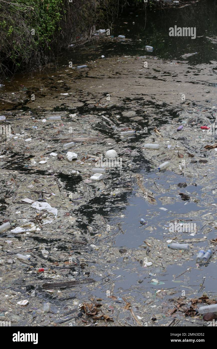A giant floating rubbish heap floating in the river, plastic pollution ...