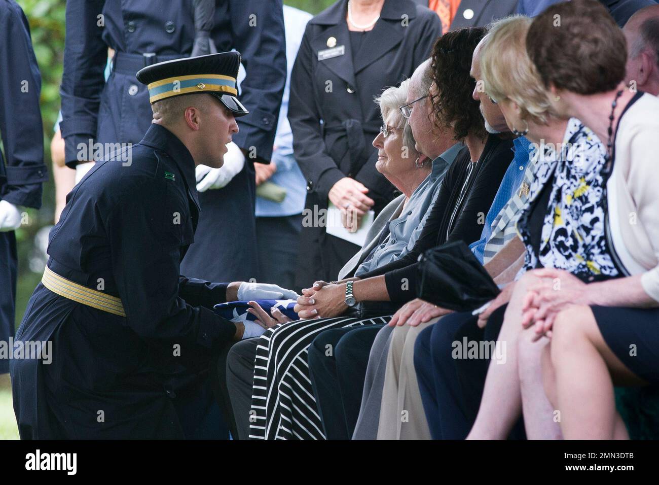 Army Capt. Lukas Findley presents an American flag to Nancy Farrell ...