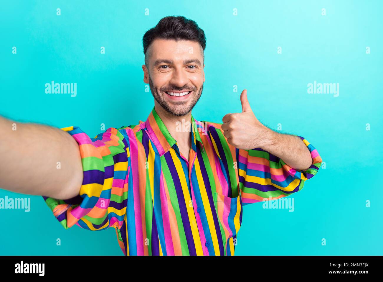 Photo of good mood positive man with brunet hair dressed striped shirt ...